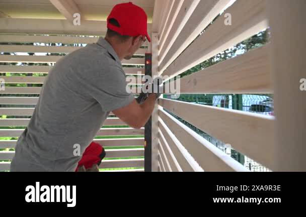 Installing Wooden Louvers on a Pergola Stock Video Footage - Alamy