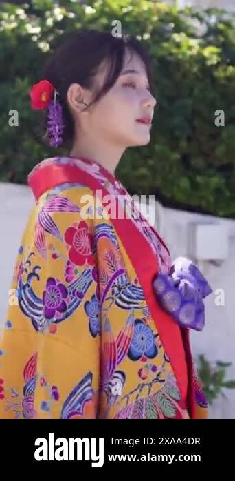 A young woman in her twenties, wearing traditional Ryusou, uses stairs ...