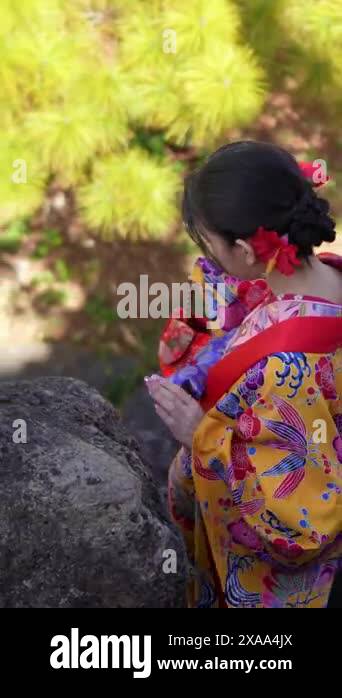 A young woman in her twenties, wearing traditional Ryusou, uses stairs ...