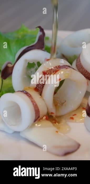 Cooking octopus. Seafood being boiled. Chef taking out big octopus with ...