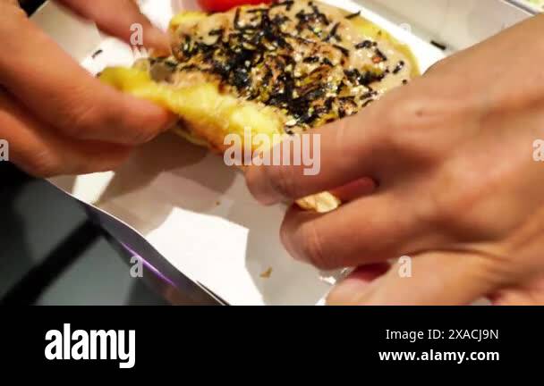 A hand to take a slice of Gamchi or Korean Bread which has a variety of ...