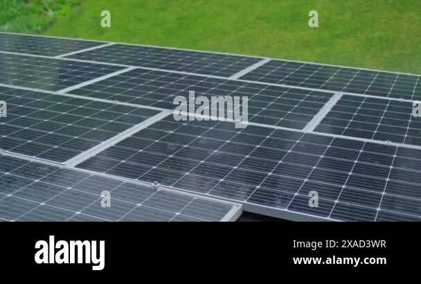 Heavy rain is falling on solar panels installed on the roof of a ...