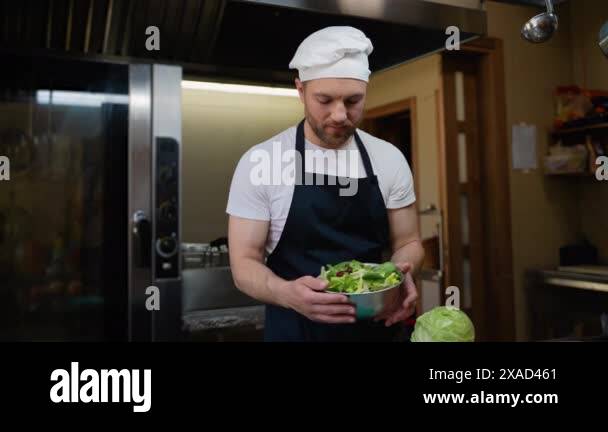 Healthy eating. Chef making fresh vegan salad. Food cooking, profession ...