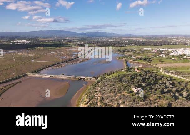 Aerial footage of the river delta, dam, agricultural lands and marshes ...