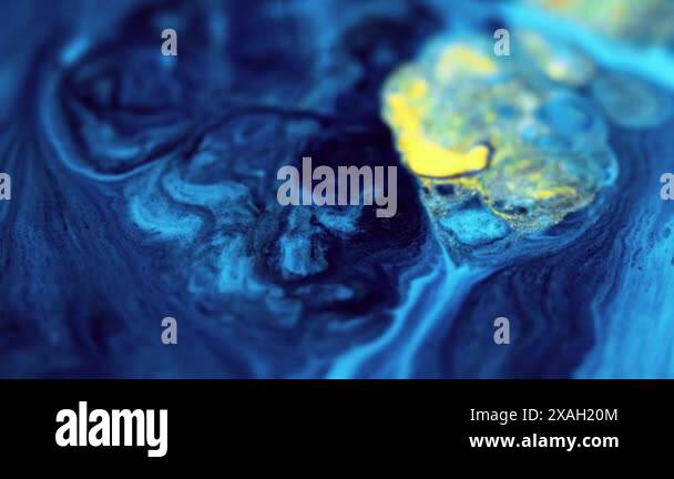 Paint flow. Sparkling ink spill. Defocused blue yellow color fluid ...