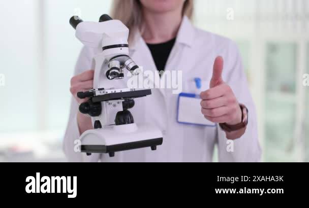 Scientist holding microscope and thumbs up approved scientific research ...