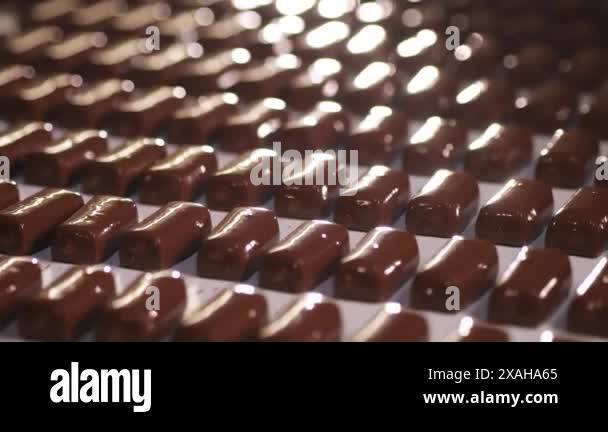 Conveyor belt in a chocolate factory. Candy production. Chocolate ...