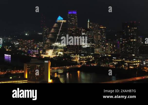 Bright lights and reflections of downtown Austin skyline at night over ...