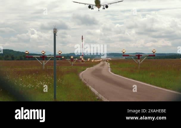 Landing strip with passenger airplane flying down and touch ground ...