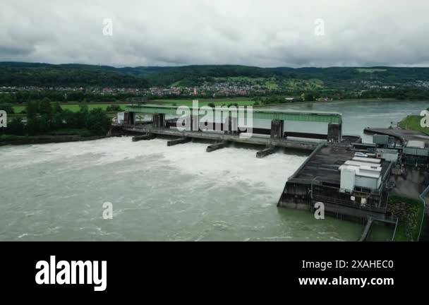 Impressive stream of water cascade falling at hydroelectric dam. Water ...