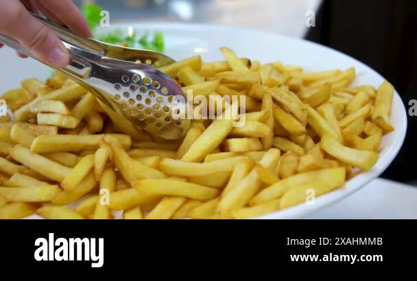 man buys french fries in the mall. a young guy picks up a frozen shred ...