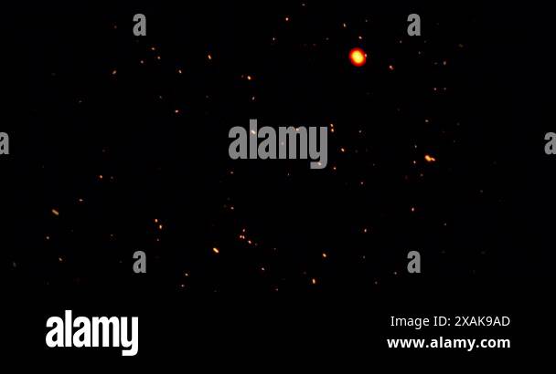 Realistic surreal ember fire dust slowing rising up on black bg 4K ...