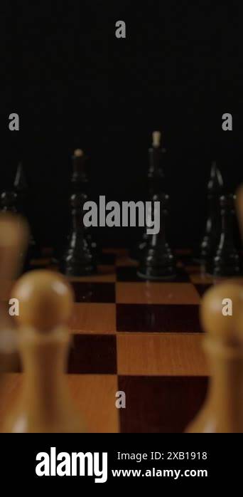 Dolly shot throw chess pieces ready to game. Refocusing from black to ...