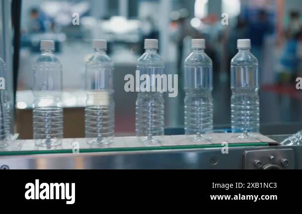 Production of Plastic Bottles. Row of Empty Bottles on an Assembly Line ...