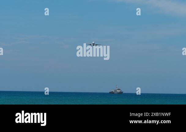 Airplane flying over a cargo ship at day, symbolizing global logistics ...