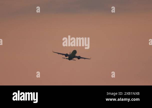 Airplane climbing in the sunset sky, rear view. Footage of aircraft ...