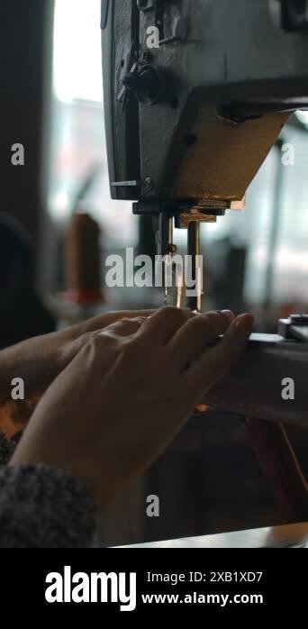 Seamstress working on sewing machine, stitching textile, fabric. Sewing ...