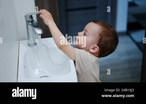 Faucet child Stock Videos & Footage - HD and 4K Video Clips - Alamy