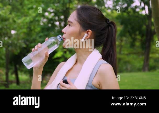 Happy healthy woman drinking water from bottle after workout exercise ...