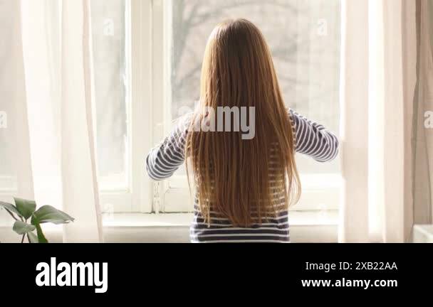 Little girl window shake healthy hair going looking at camera smiling ...