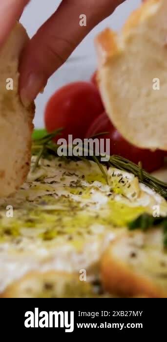 Three hands dip croutons in emergency Normandy Camembert baked in the ...