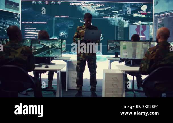 Infantry unit leader examines big data on a screen in military ...