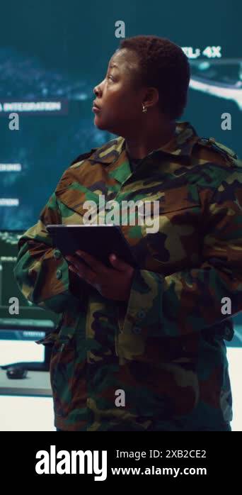 Vertical Video Woman sergeant major working on deployment of electronic warfare tools to disrupt ...