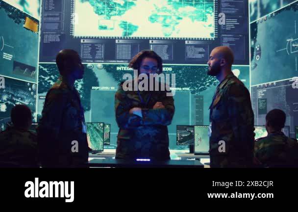 Army superior officers creating an attack plan using a hologram to gather real time information ...