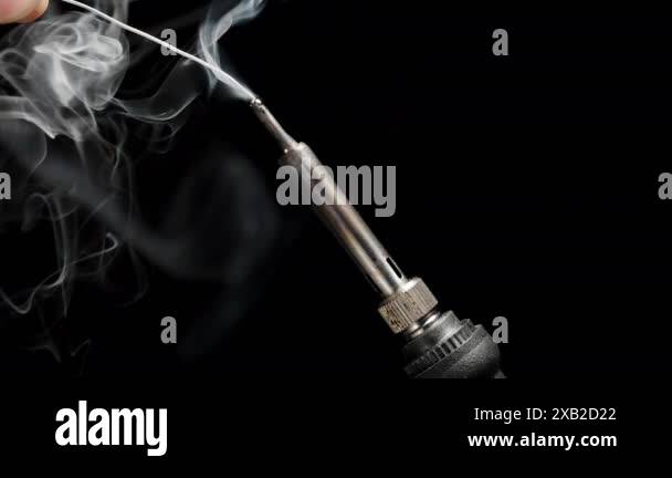 Soldering Iron Close-Up on Black Background Emitting Smoke from Melting ...