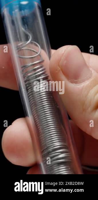Vertical video. Tin Solder for Soldering Iron Coiled in Spiral in ...