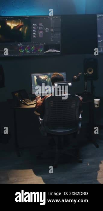 The video editor works in studio on computer, uses color grading ...