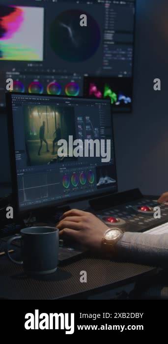 African American film maker makes color grading on computer in modern ...