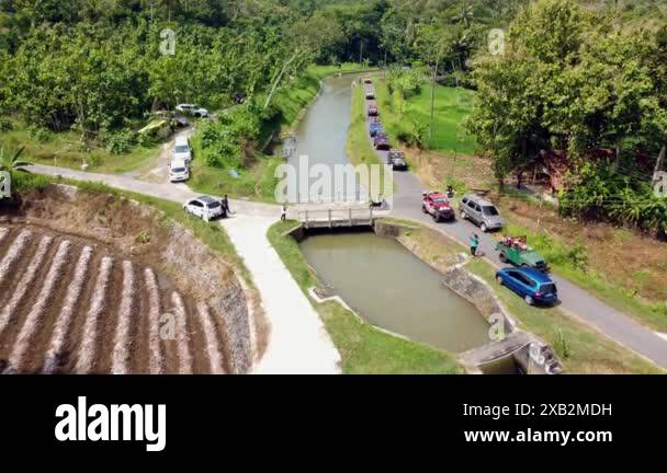 Aerial footage of a jeep tour in a rural area with a drainage ditch on ...