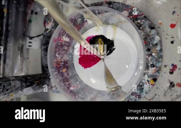 paint mixing workshop. Mixing different colors of paint in a jar and ...