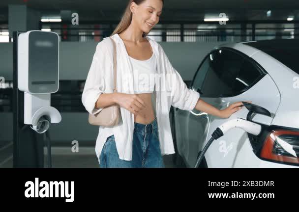 Slow motion woman happy and smile travel with EV electric car to shopp ...