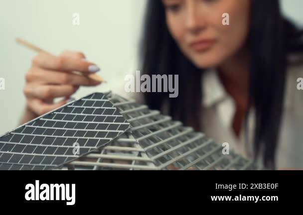 Professional young beautiful architect engineer using ruler and pencil measuring model roof ...