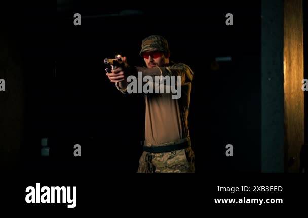 at a professional shooting range military trainer reloading a pistol ...