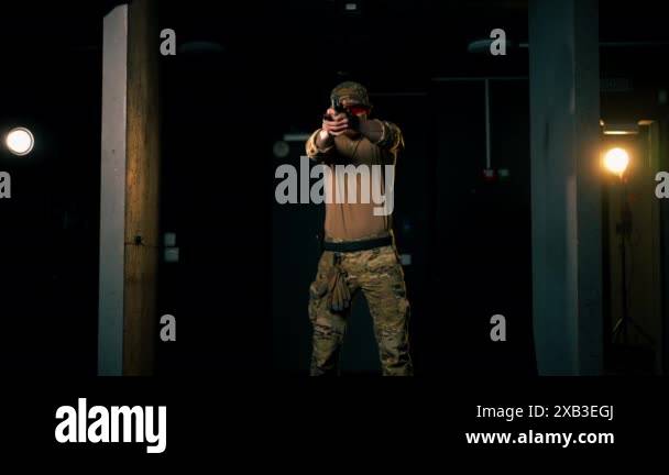 at a professional shooting range military trainer reloading a pistol ...