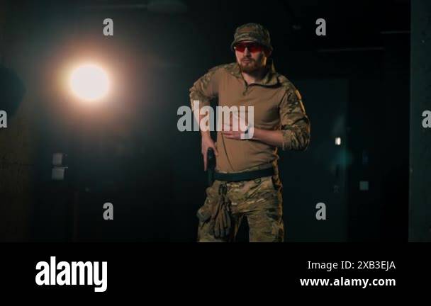at a professional shooting range military trainer reloading a pistol ...