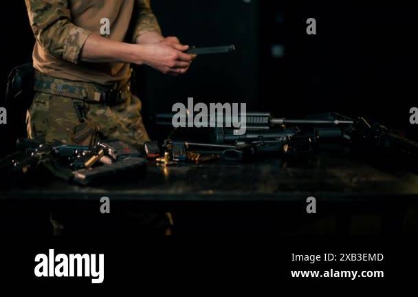 in a professional shooting range a professional fighter assembles a ...