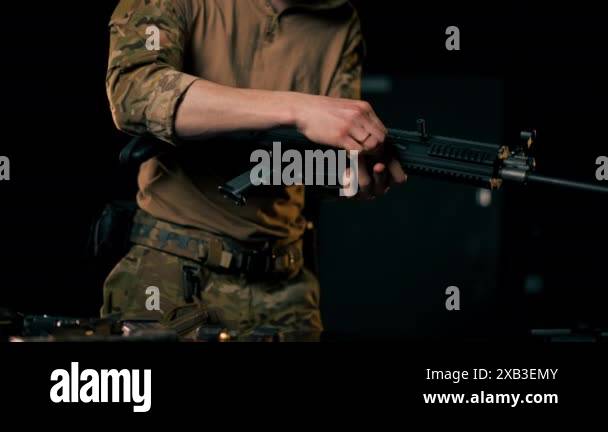 in a professional shooting range a professional fighter assembles a ...