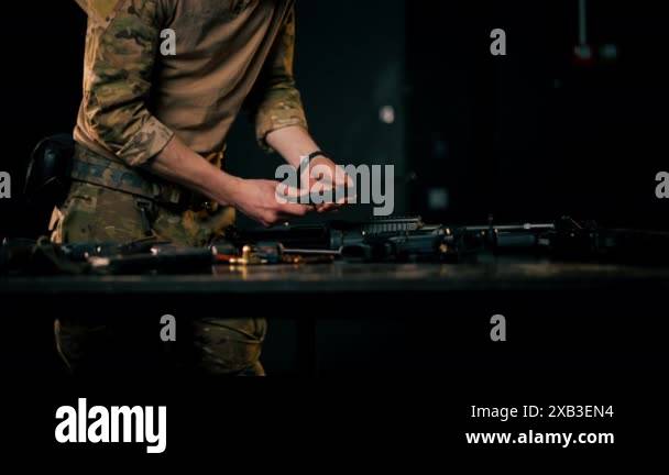 in a professional shooting range a professional fighter assembles a ...