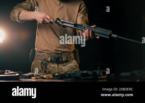 in a professional shooting range a professional fighter assembles a ...