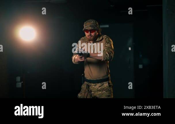 at a professional shooting range military trainer reloading a pistol ...