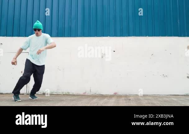 Full body of youthful hipster moving in lively groove at street ...