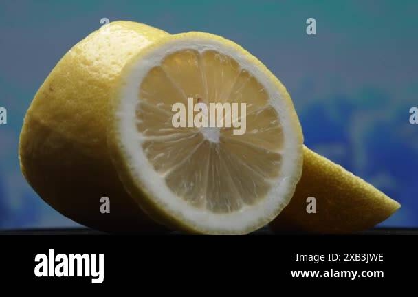 A slice of fresh lemon, bright yellow and vibrantly citric, lies ...