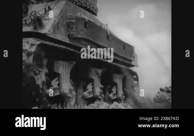 1945 - Tanks move across camera and US marines run across open terrain ...