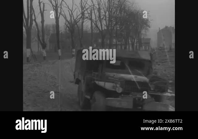 1944 - US Army jeeps are completely wrecked at the side of a muddy road ...