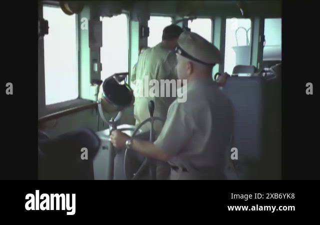 1966 - The captain of the USNS Barrett navigates the ship from the ...
