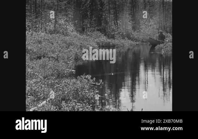 CANADA - 1932 - A Native American ranger in Canada travels a river by ...